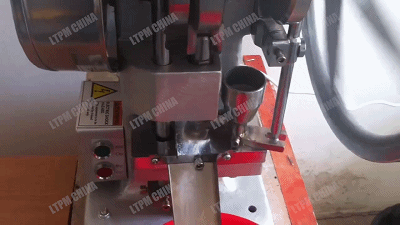 What is a single station tablet press and how does it work?